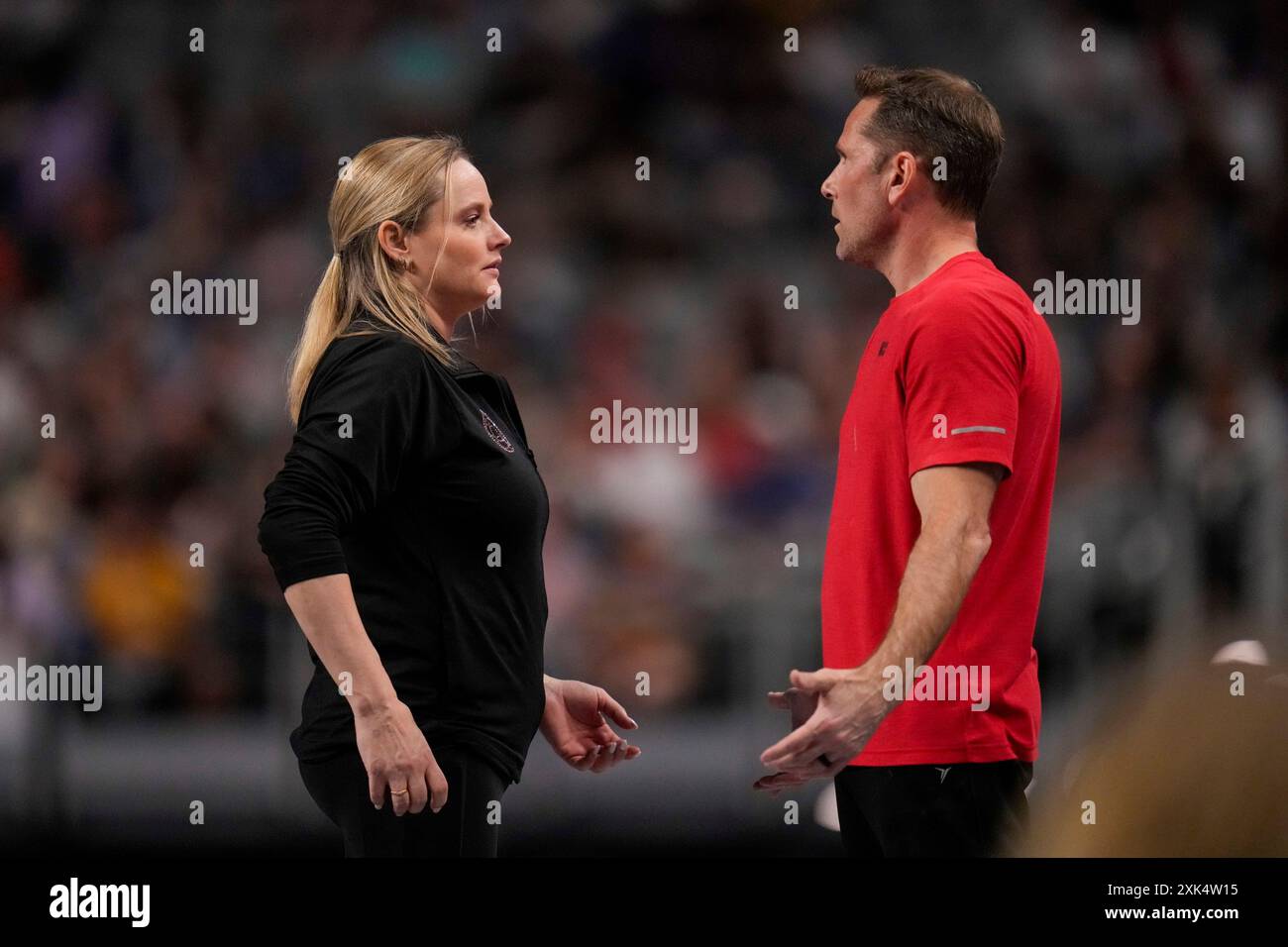 FILE - Cecile & Laurent Landi, coaches of Simone Biles, chat before she ...