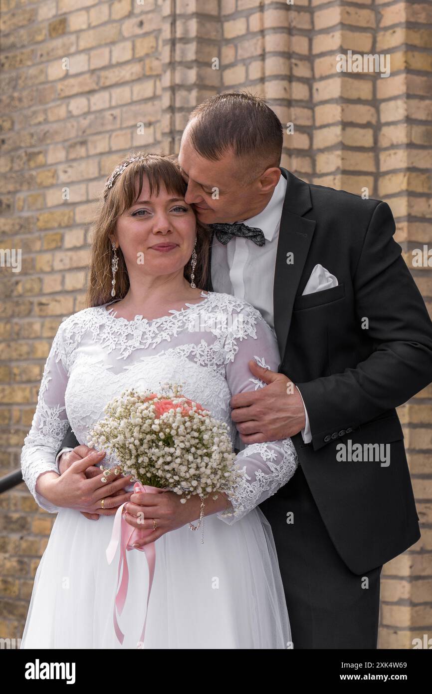 The bride and groom are standing on the steps after registering their ...