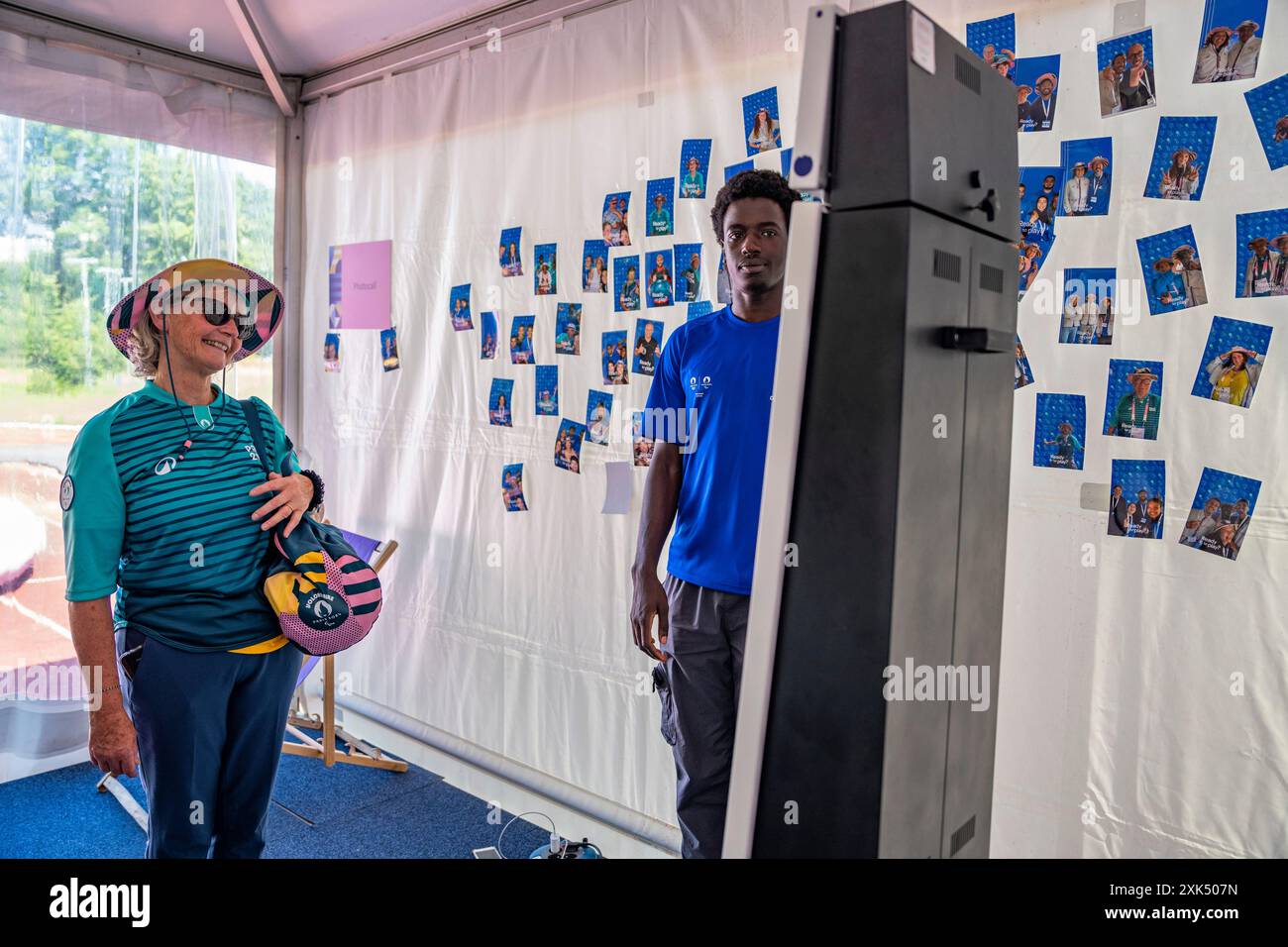 Paris, France. 19th July, 2024. A volunteer (L) for Paris 2024 takes ...