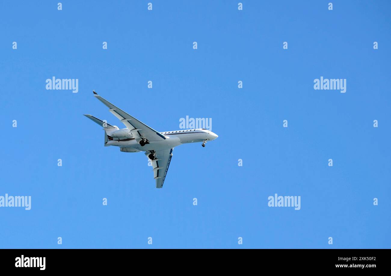 Private jet against the blue sky as it approaches Nice, France Stock ...