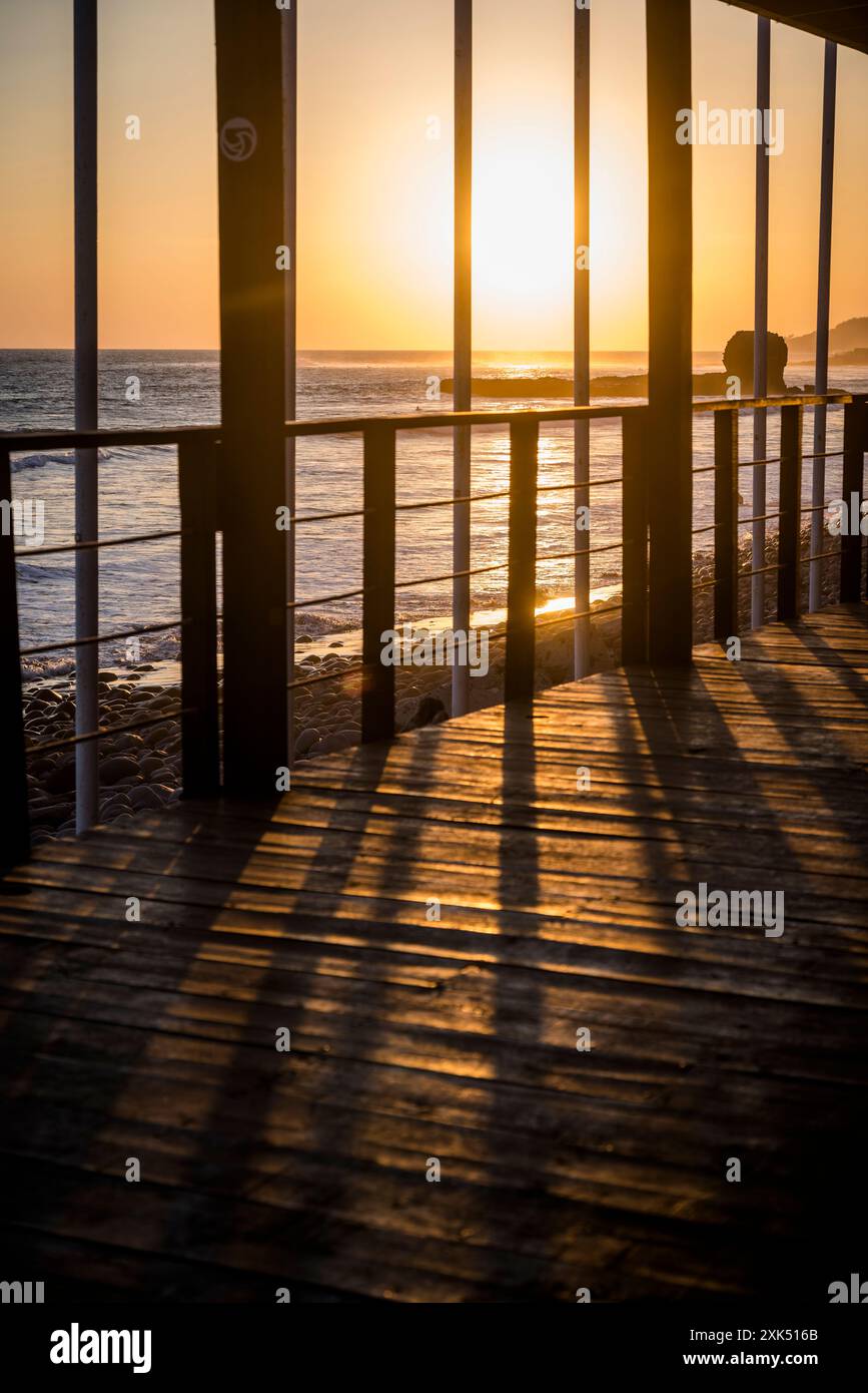 Sunset light streaming across wooden terrace, El Tunco, El Salvador ...
