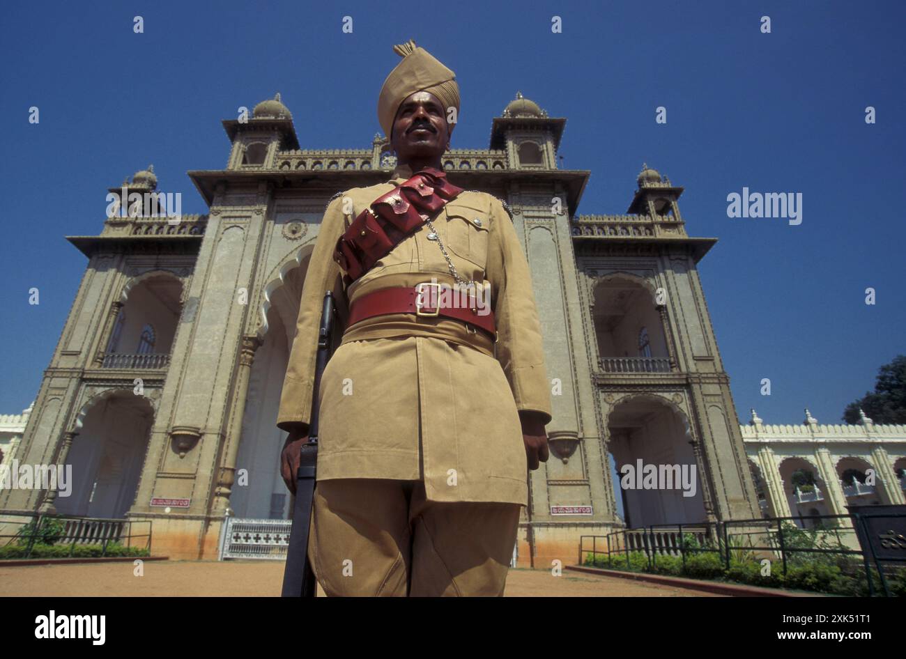 a guard at the gate of Mysore Palace or Amba Vilas Palace in the city ...