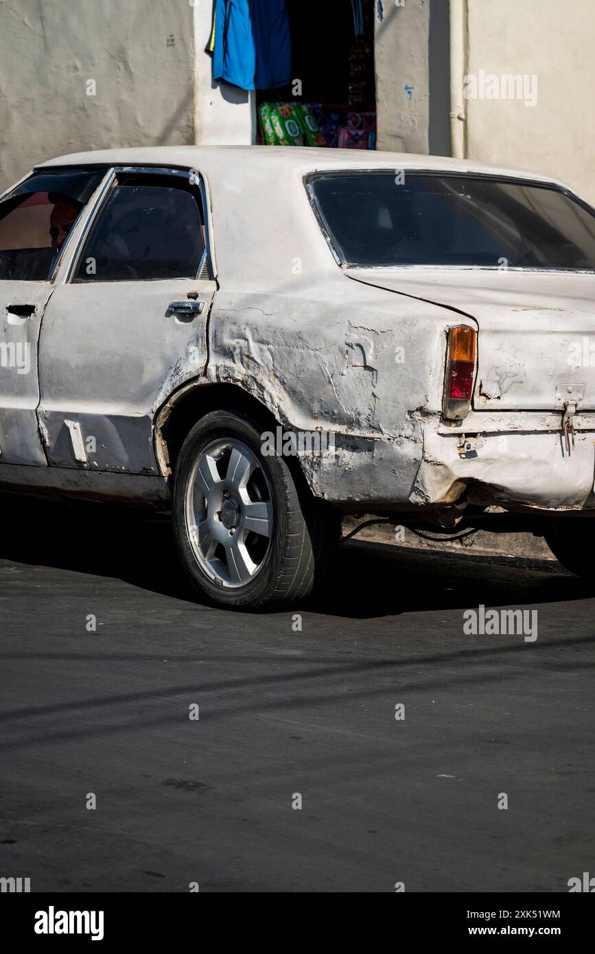 Battered old car painted white, Santa Ana, El Salvador, Central America ...