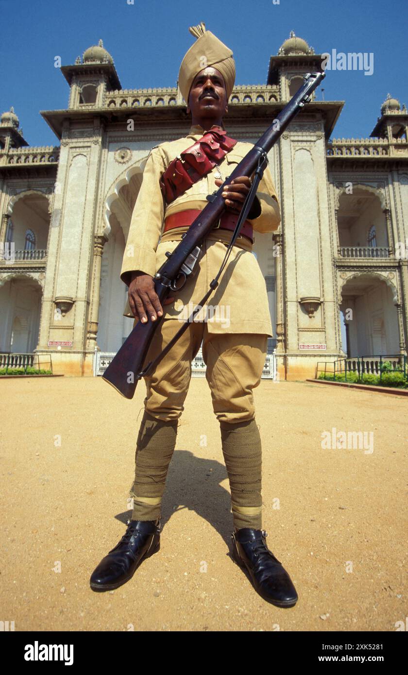 a guard at the gate of the Mysore Palace or Amba Vilas Palace in the ...