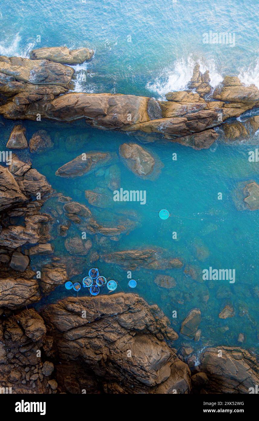 Aerial drone top view of beautiful waves crashing on the rocky island ...