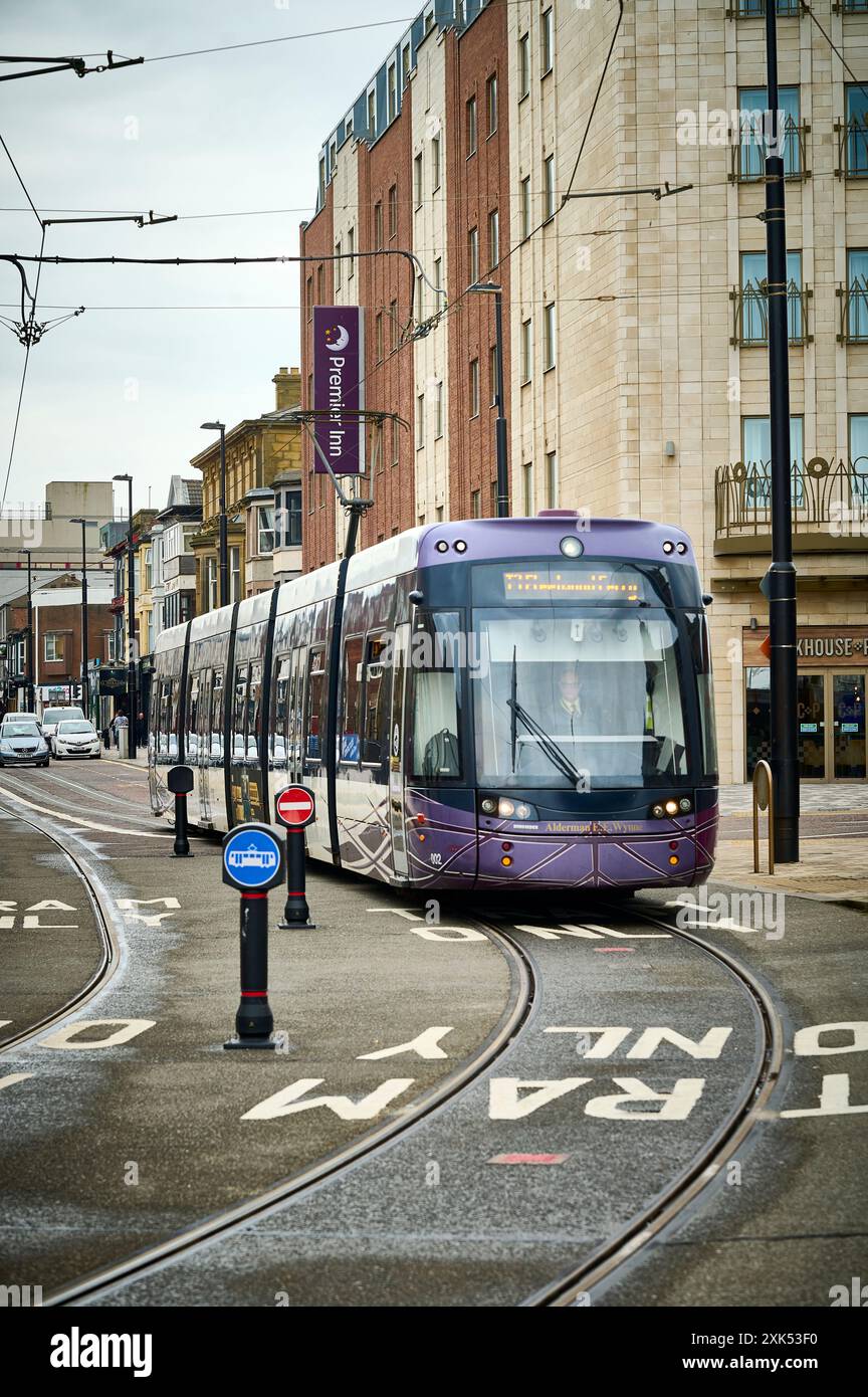 Tram travelling down Talbot Road passing Premier Inn hotel in Blackpool ...