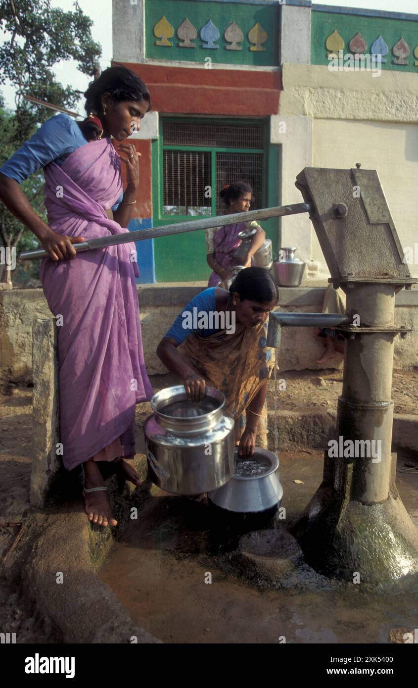 people at a public water station and water fountain in the city of ...