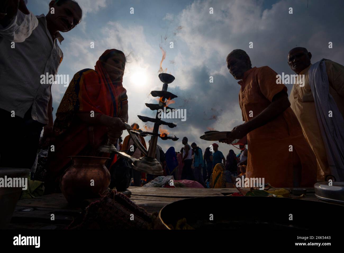 A Hindu woman performs "Aarti," a ritual involving rotating a ...