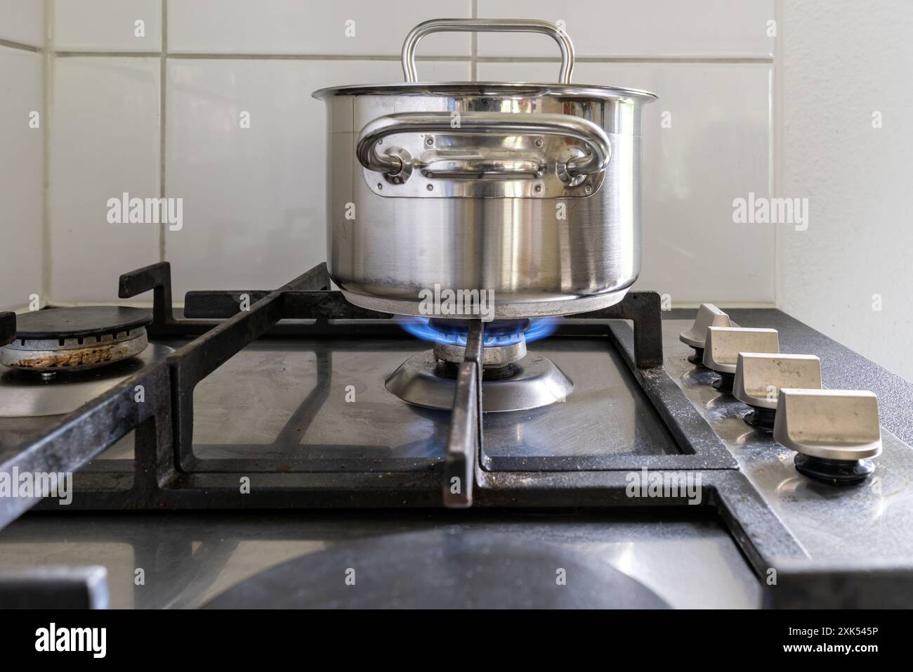 stainless steel cooking pot on gas stove Stock Photo - Alamy