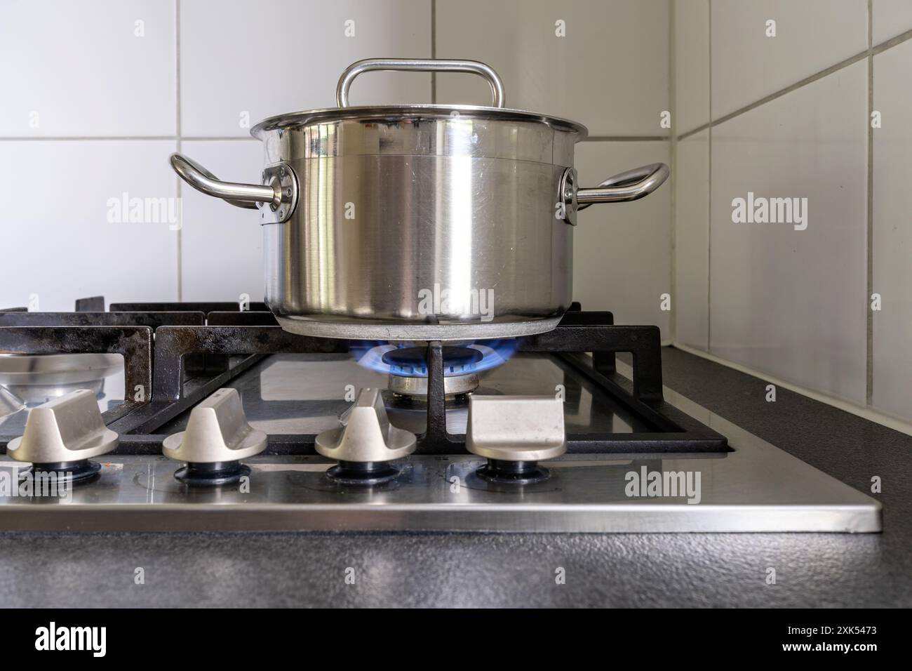 stainless steel cooking pot on gas stove Stock Photo - Alamy