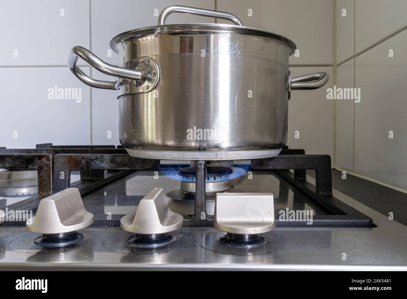stainless steel cooking pot on gas stove Stock Photo - Alamy