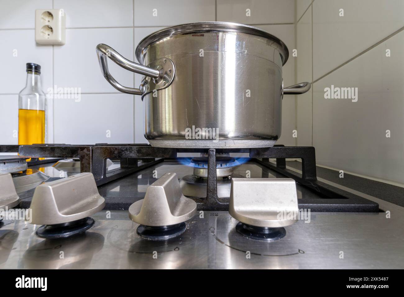 stainless steel cooking pot on gas stove Stock Photo - Alamy