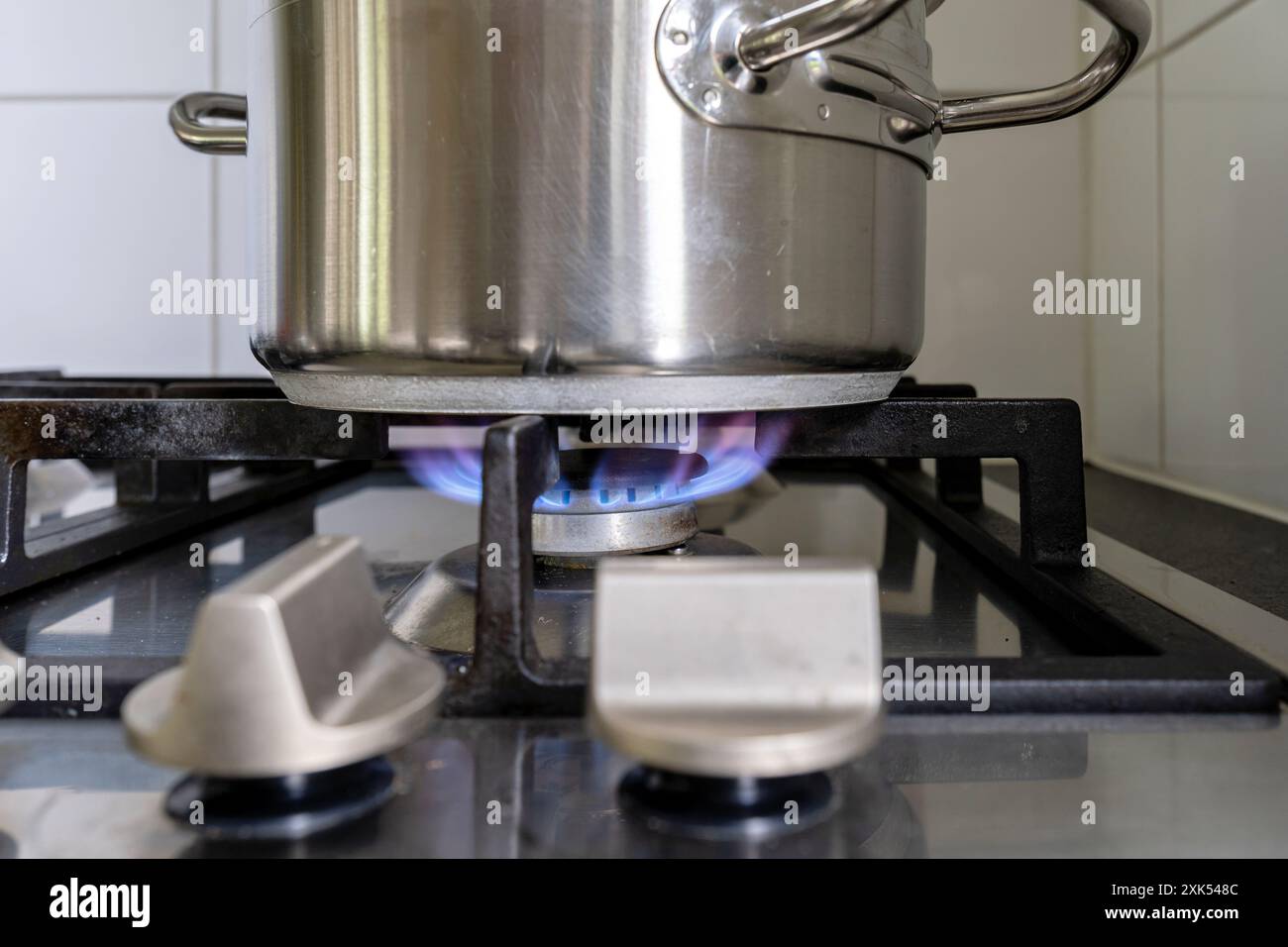 stainless steel cooking pot on gas stove Stock Photo - Alamy