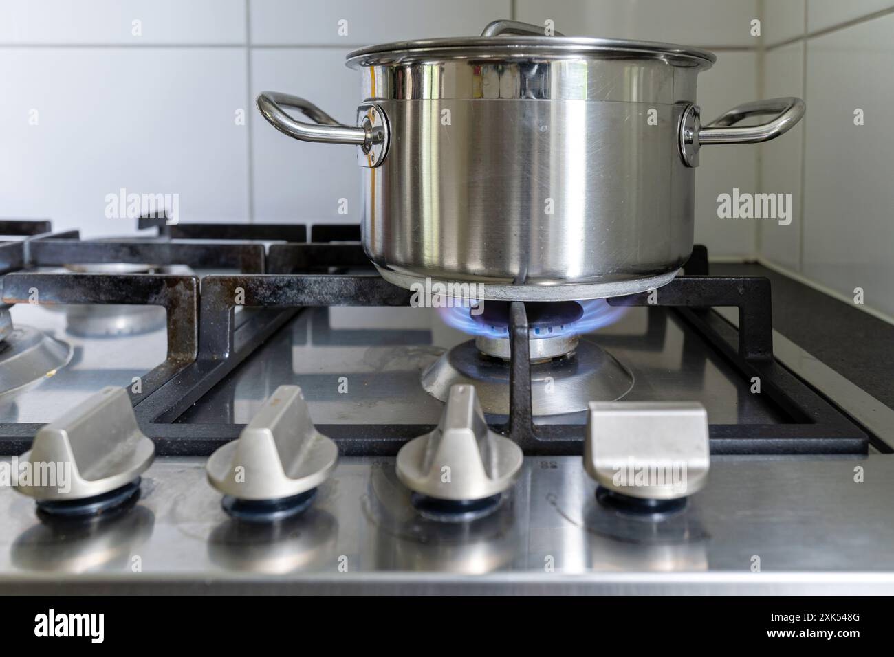 stainless steel cooking pot on gas stove Stock Photo - Alamy