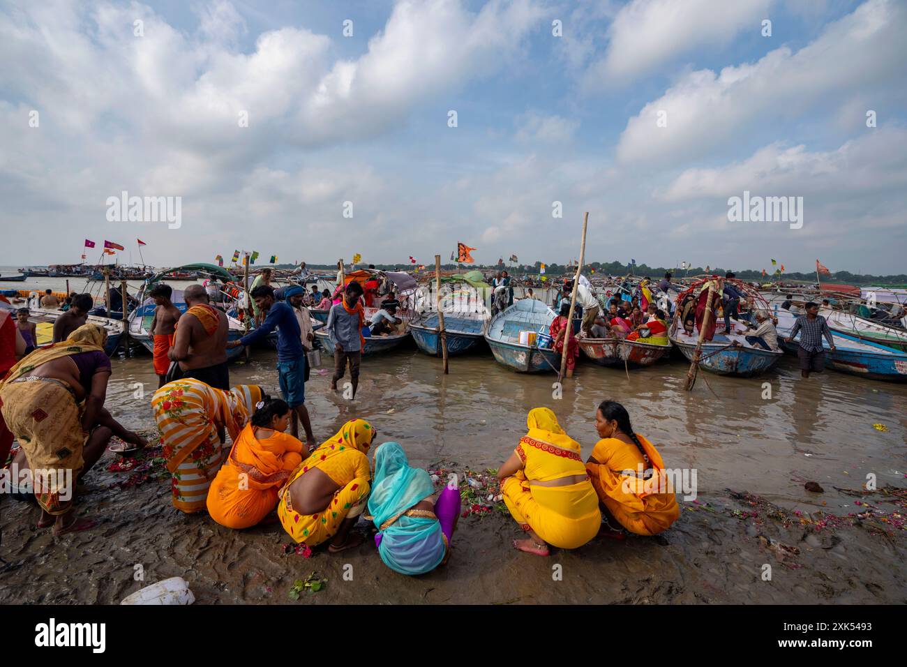 Hindu devotees pray after taking a holy dip at Sangam, the confluence ...