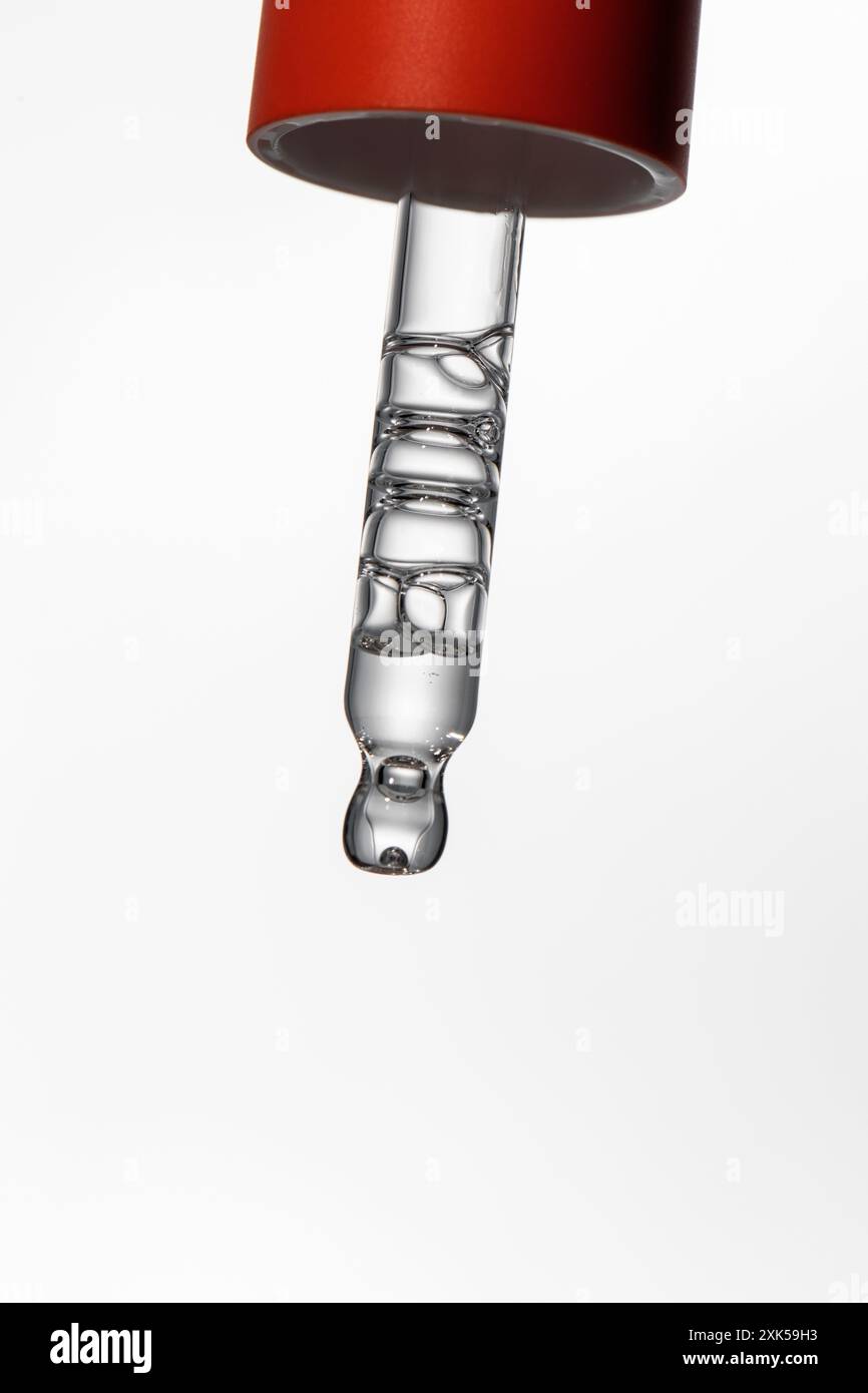 Dripping antiaging serum with pipette on white background Stock Photo ...