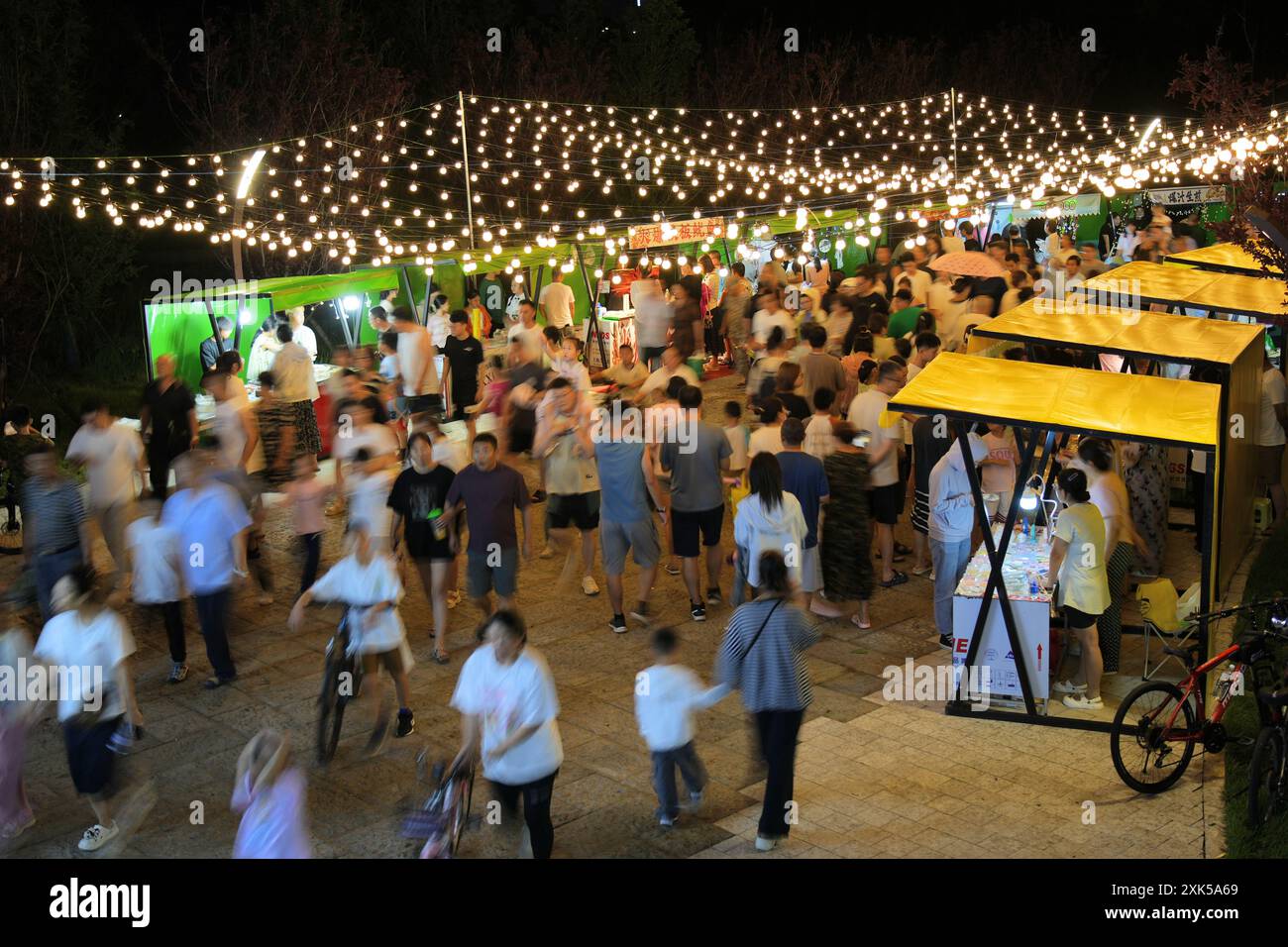 YANTAI, CHINA - JULY 20, 2024 - Tourists visit the riverside night ...