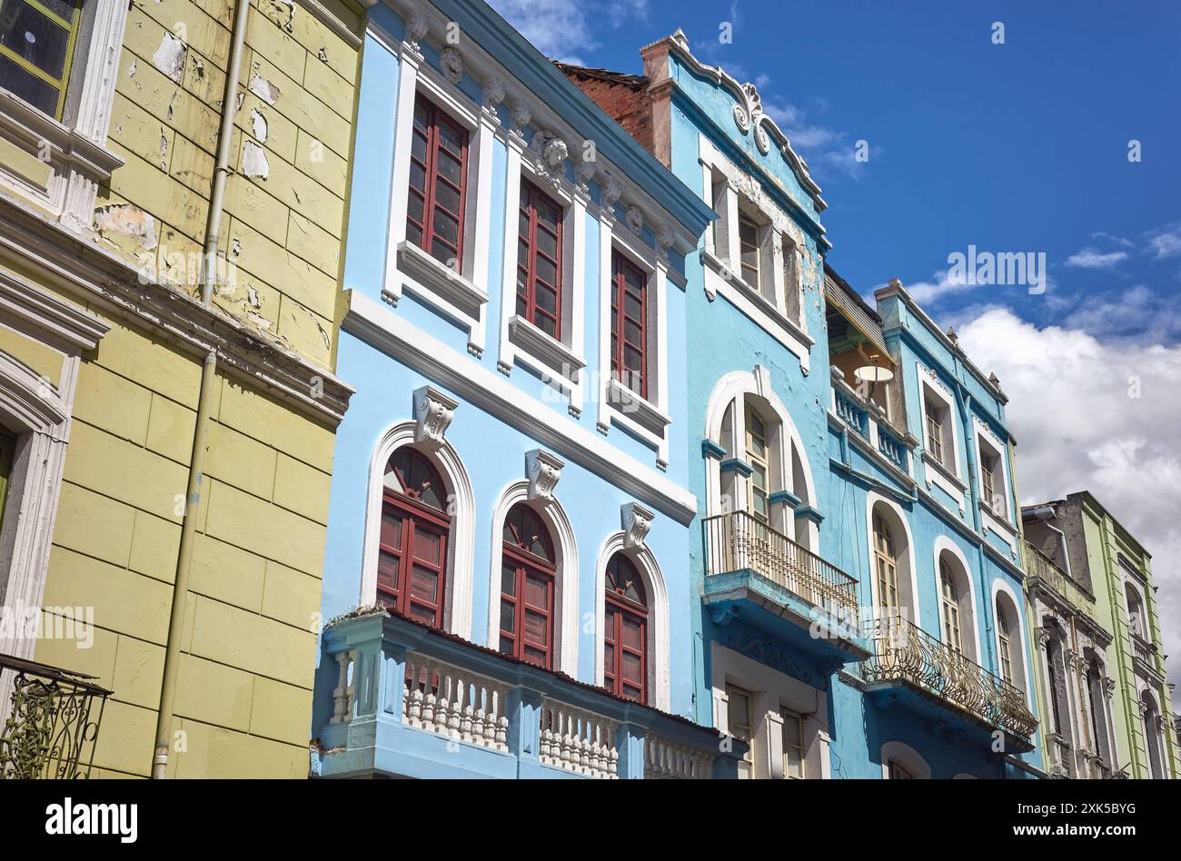Street view of facades of old colonial buildings in Quito, Ecuador ...
