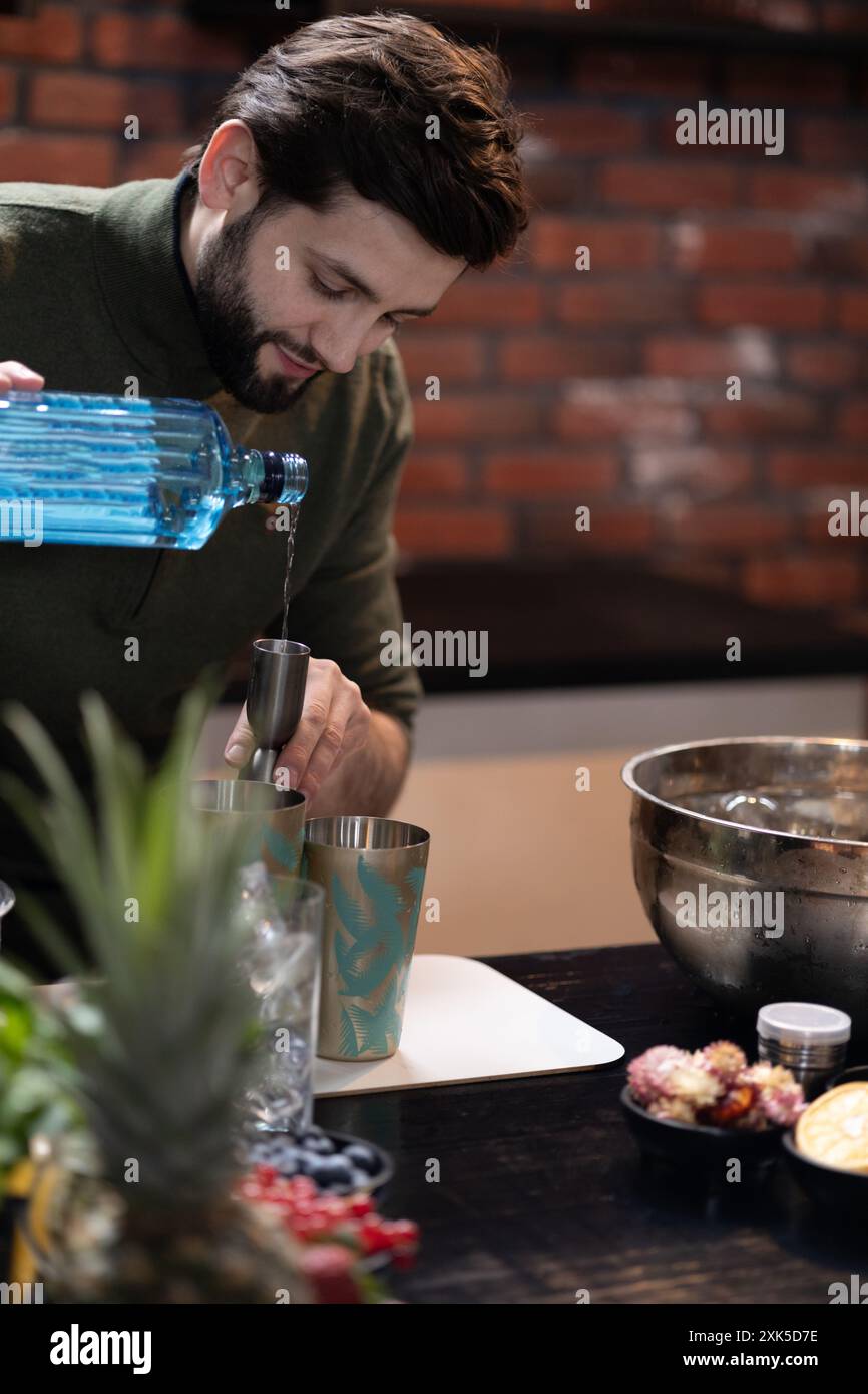 Bartender Pouring Liquid Into Cocktail Shaker Stock Photo - Alamy