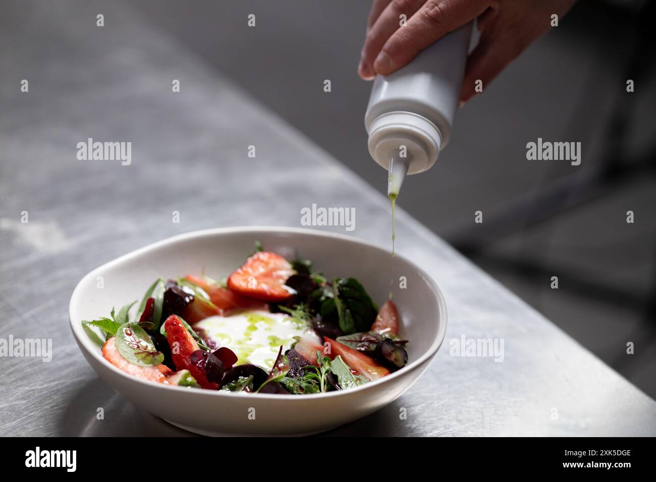 Chef Drizzling Salad With Dressing Stock Photo - Alamy