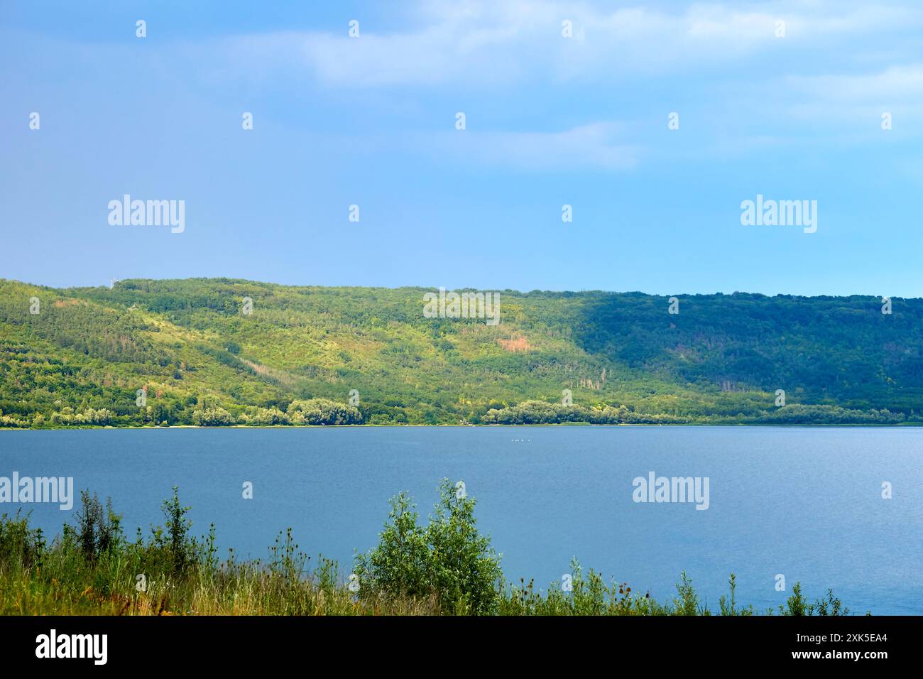 a large natural stream of water flowing in a channel to the sea, a lake ...