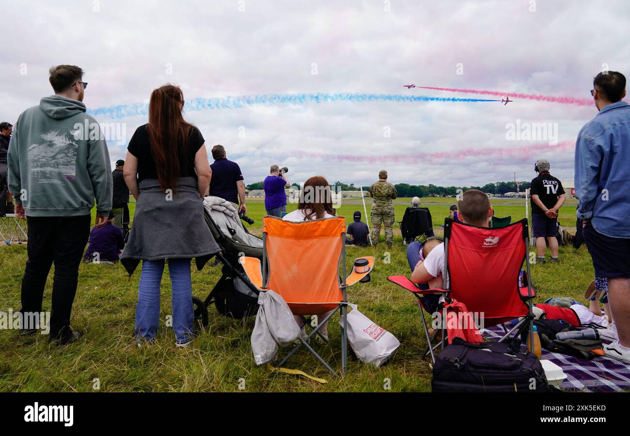 People look on as the Red Arrows display team perform during the Royal ...