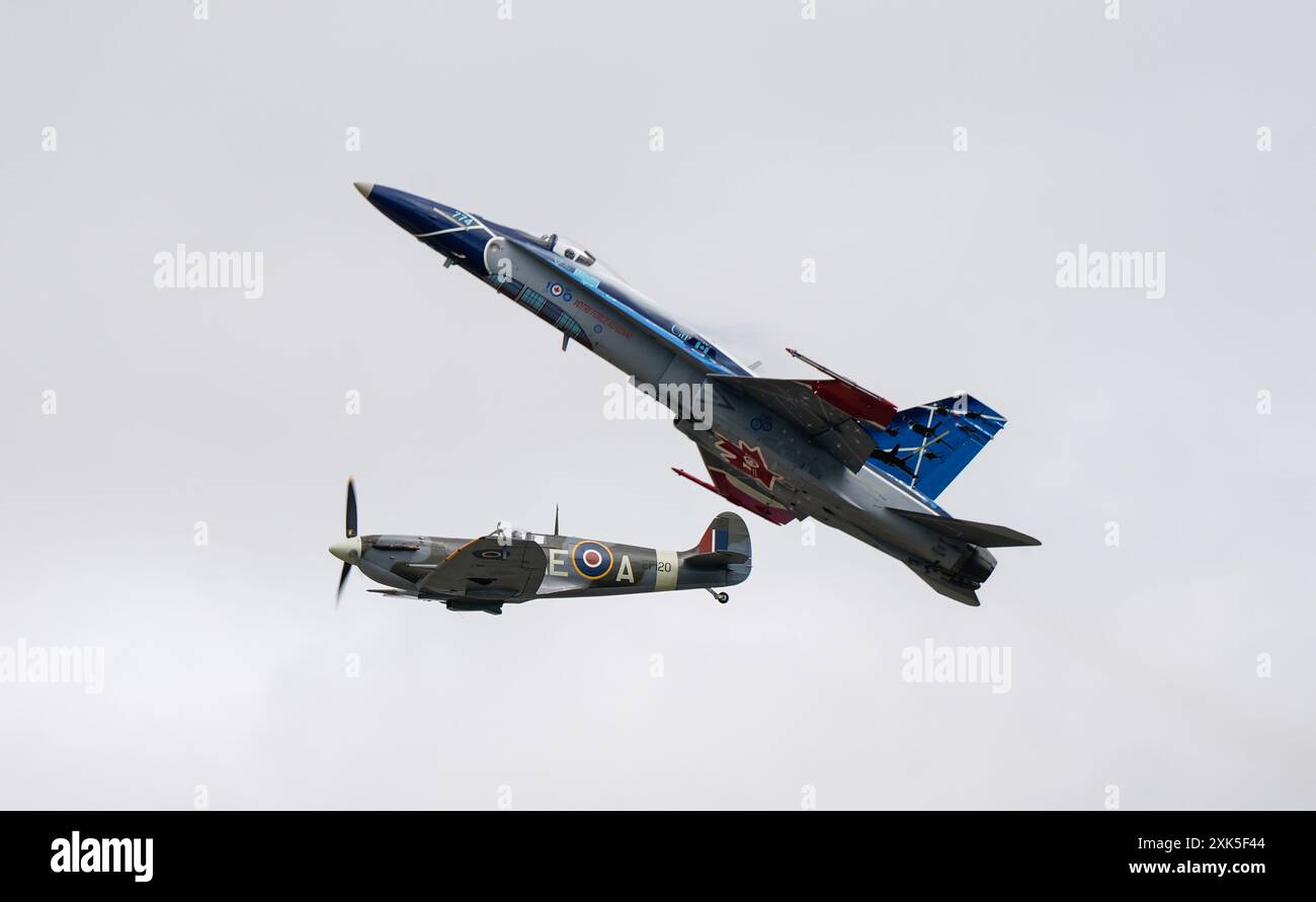 A CF-188 Hornet of the Royal Canadian Air Force flies alongside a ...