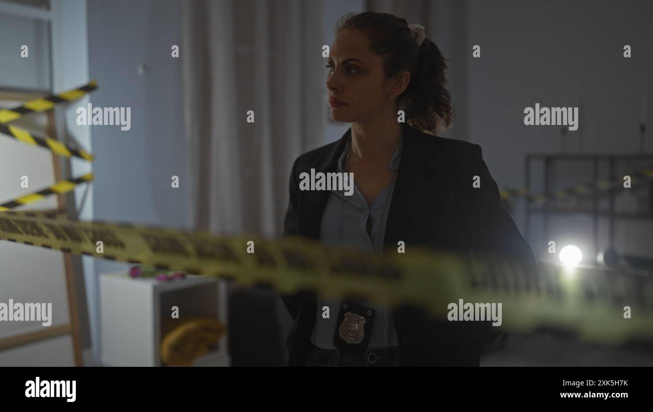 Focused female detective examines a crime scene indoors, standing ...