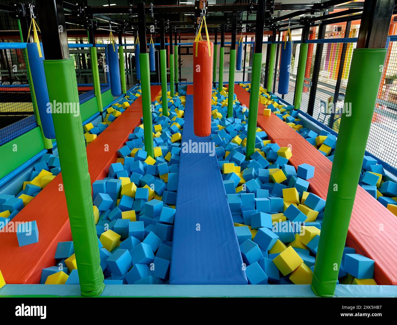 Trampoline park has blue and yellow foam cubes for kids fun Stock Photo ...