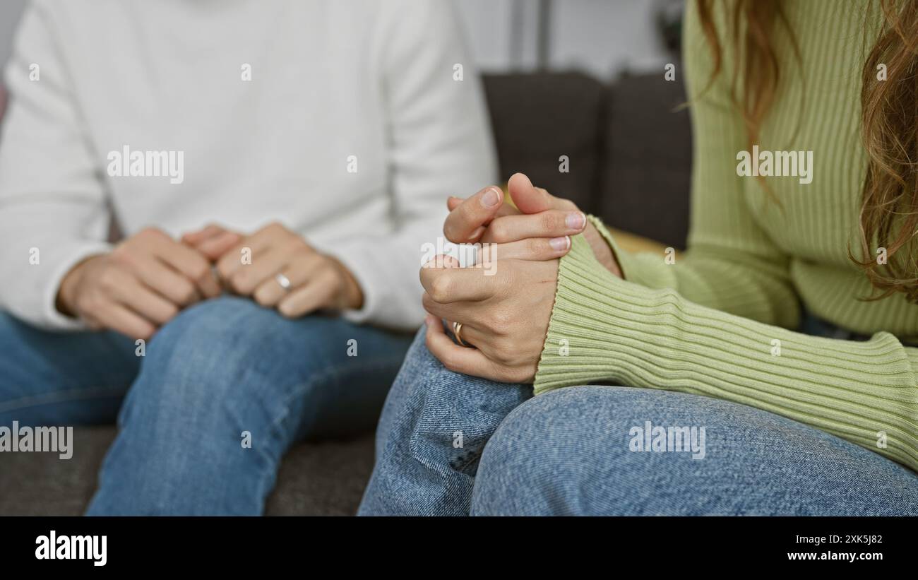 A couple holding hands indoors, showcasing a moment of love and ...