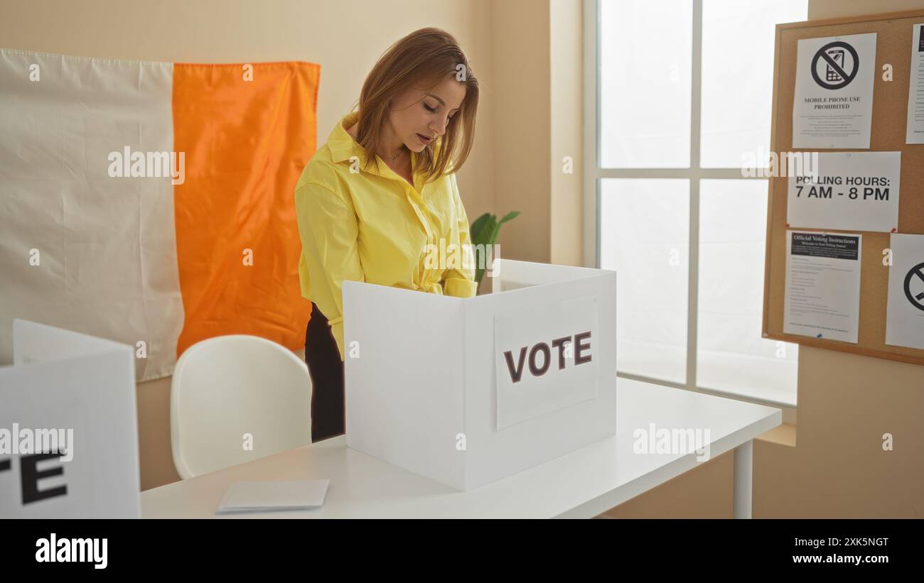 A young blonde woman is seen voting in an irish electoral college room ...