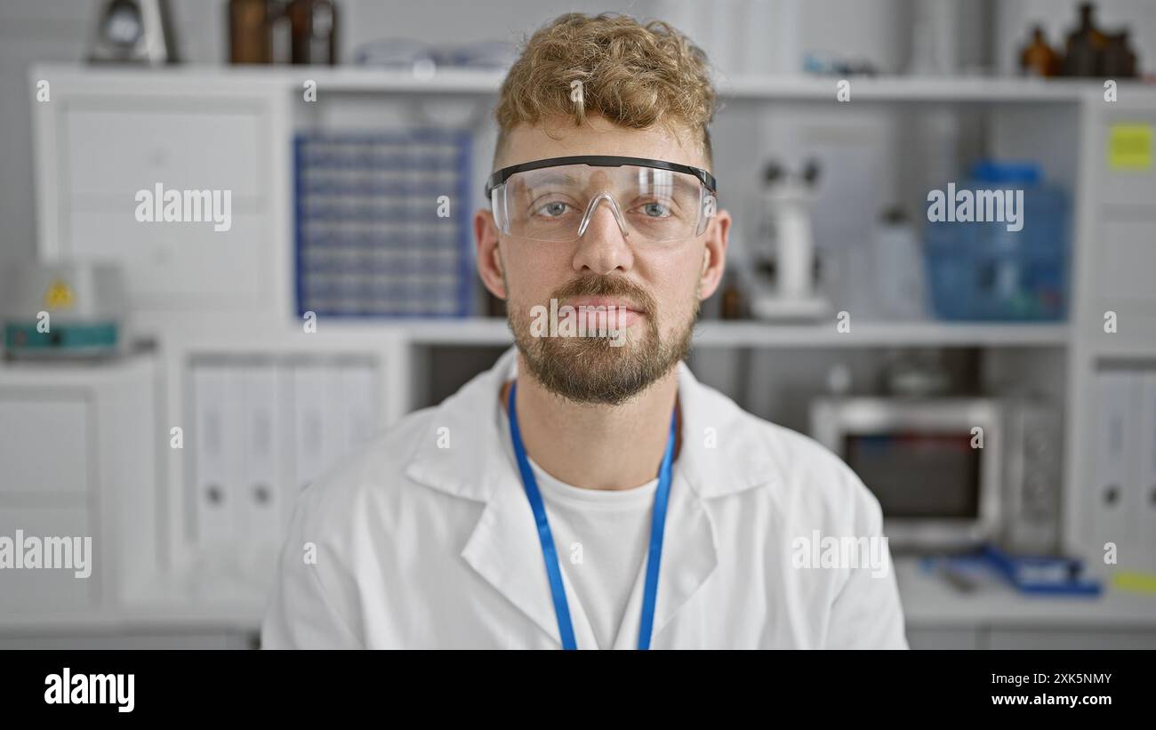 Portrait of a young caucasian man with blue eyes, beard, and safety ...