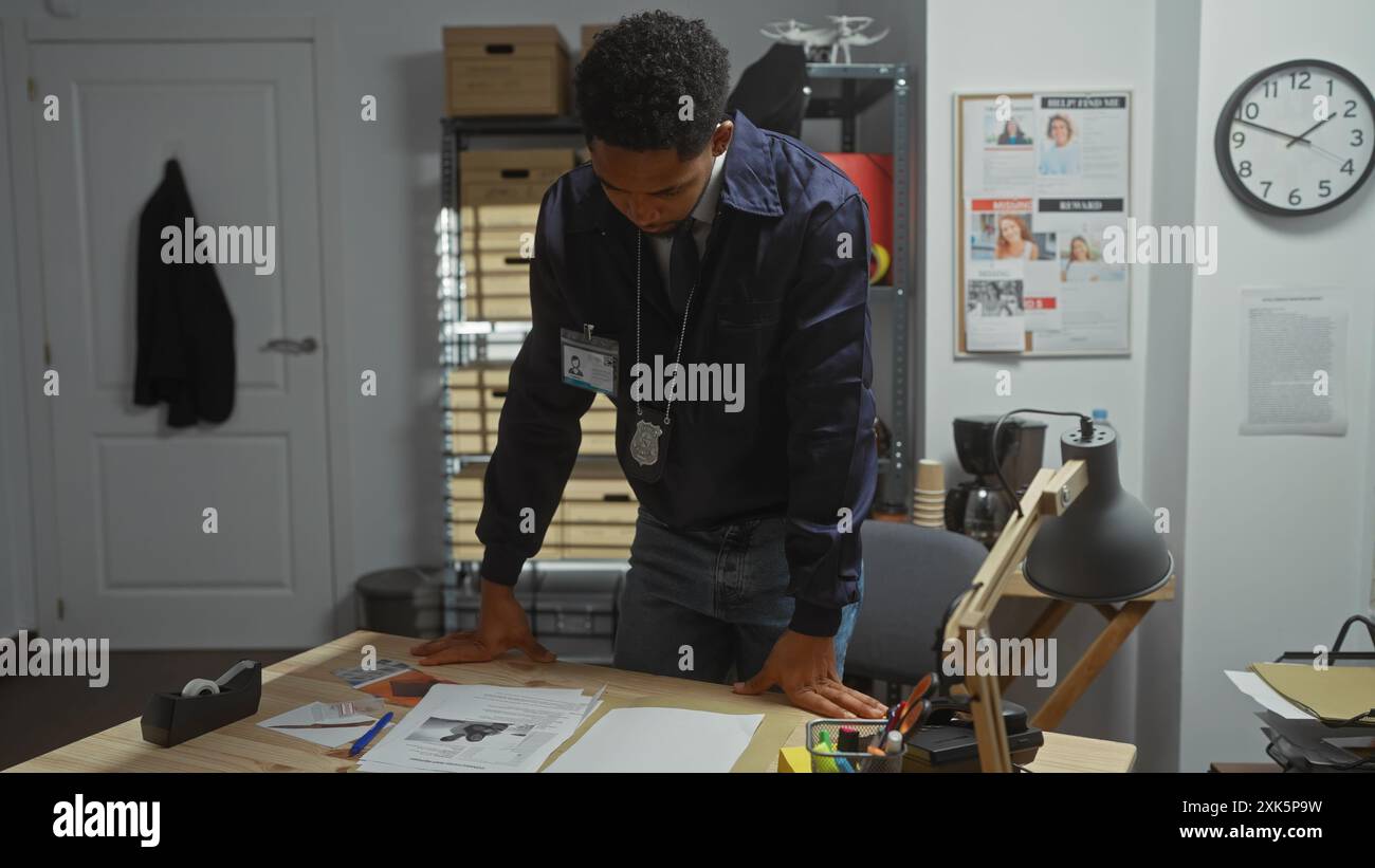 A focused african american man with a badge examines documents at a ...