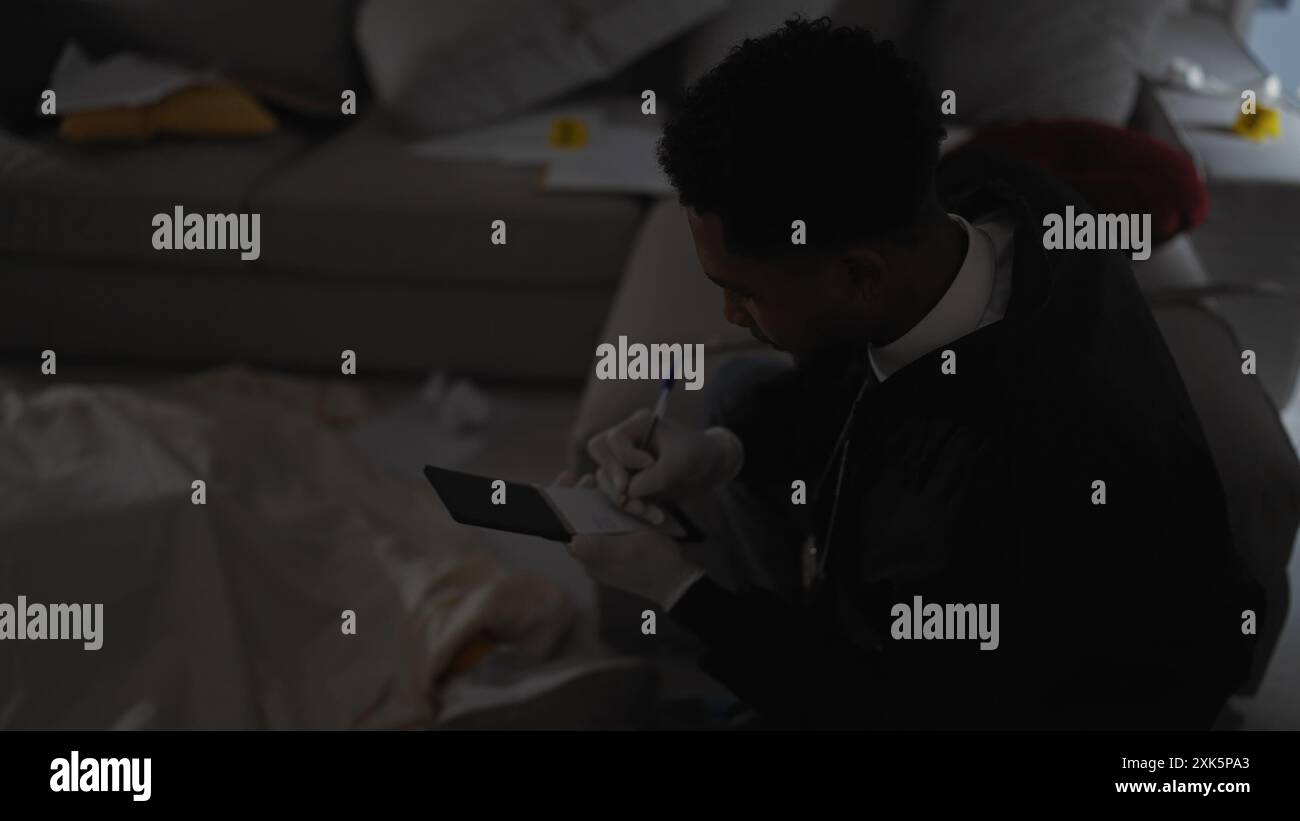 An african american man investigates a crime scene indoors while taking ...