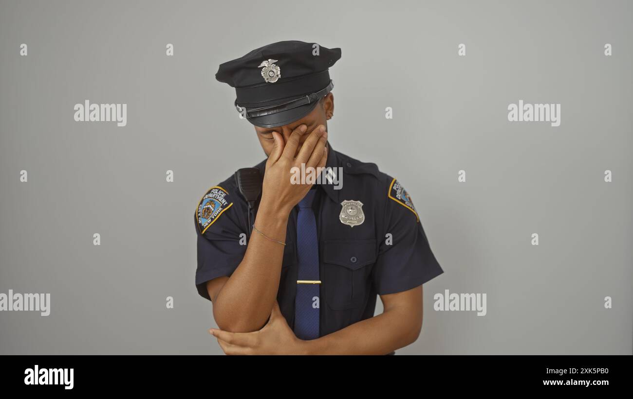 African american police officer expressing stress against a white ...