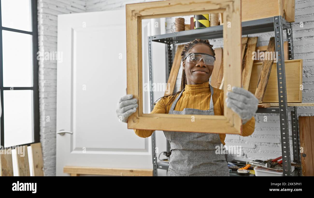 A cheerful african american woman with braids working indoors at a ...