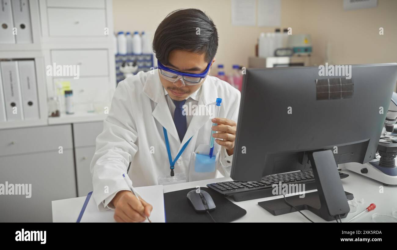 Asian man in lab coat taking notes in a clinical laboratory setting ...