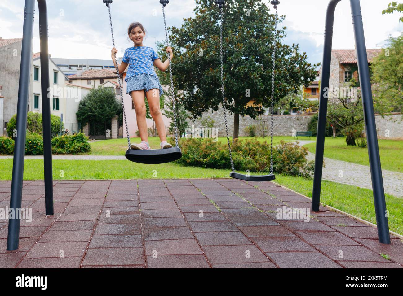 Kid standing on swing hi-res stock photography and images - Alamy