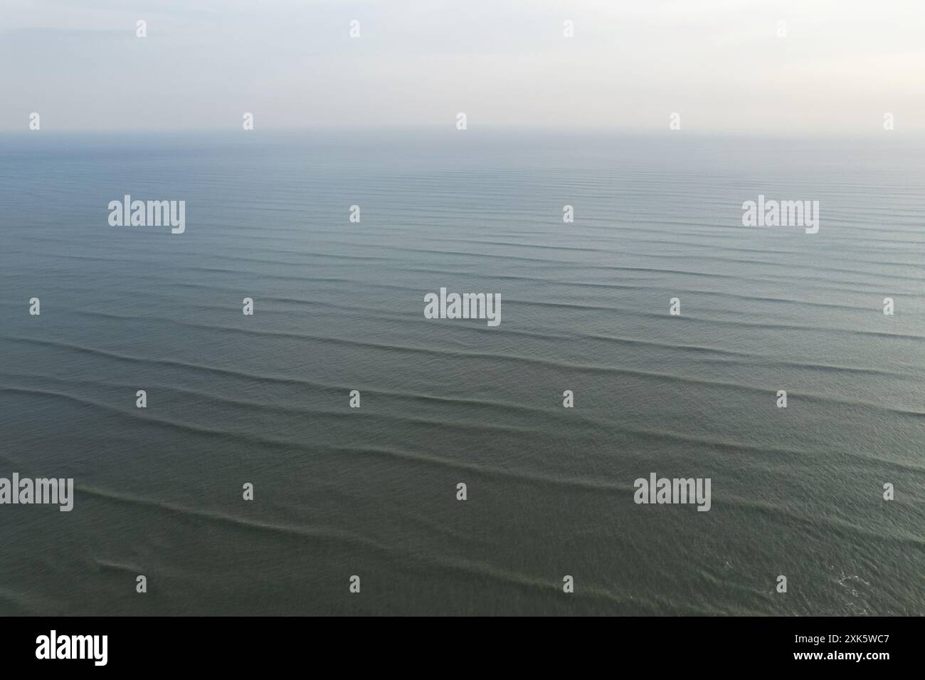 Ocean twilight aerial landscape drone view. Long waves on ocean surface ...