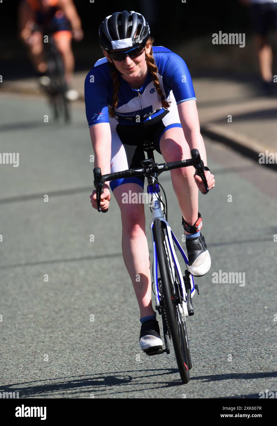 Female Triathlete riding in cycling stage of race Stock Photo - Alamy