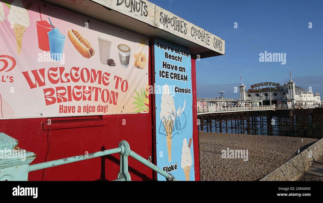 Welcome to Brighton sign on a seafront cafe in front of Brighton Palace ...