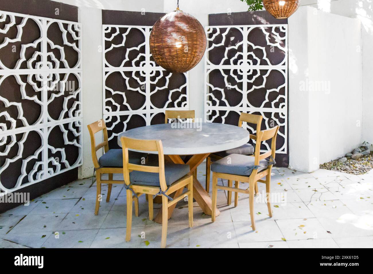 Outdoor patio dining table with a decorative background and hanging ...