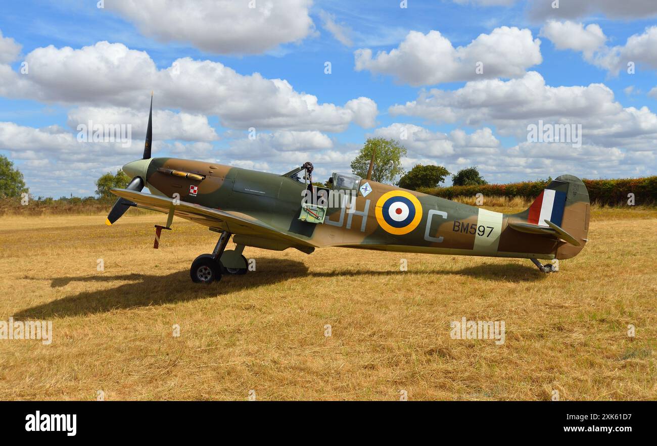 Vintage Spitfire BM597 (G-MKVB) Mk.Vb static on airstrip with blue sky ...