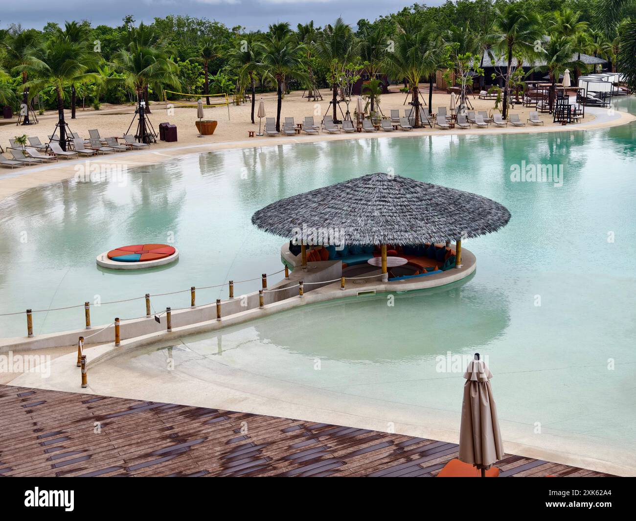 A traditional thatched hut is located within a swimming pool Stock ...