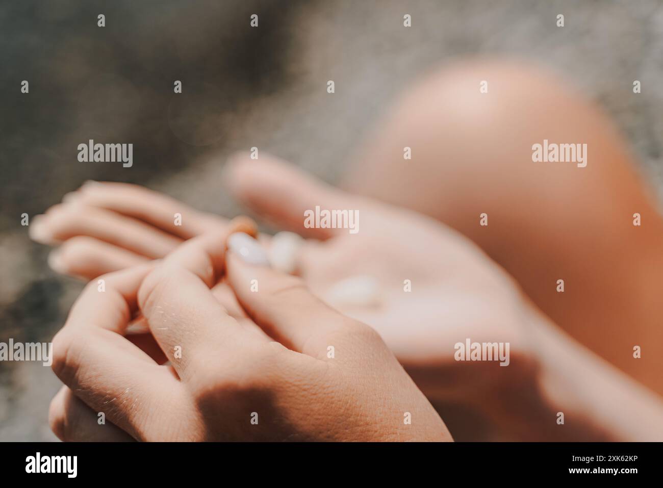 A person is holding a handful of nuts in their hand. The nuts are of ...