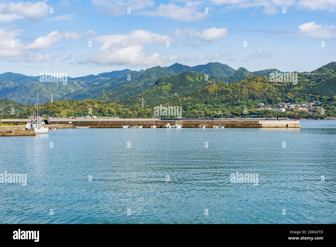 Dramatic rock formations covered with lush greenery on the coast of ...