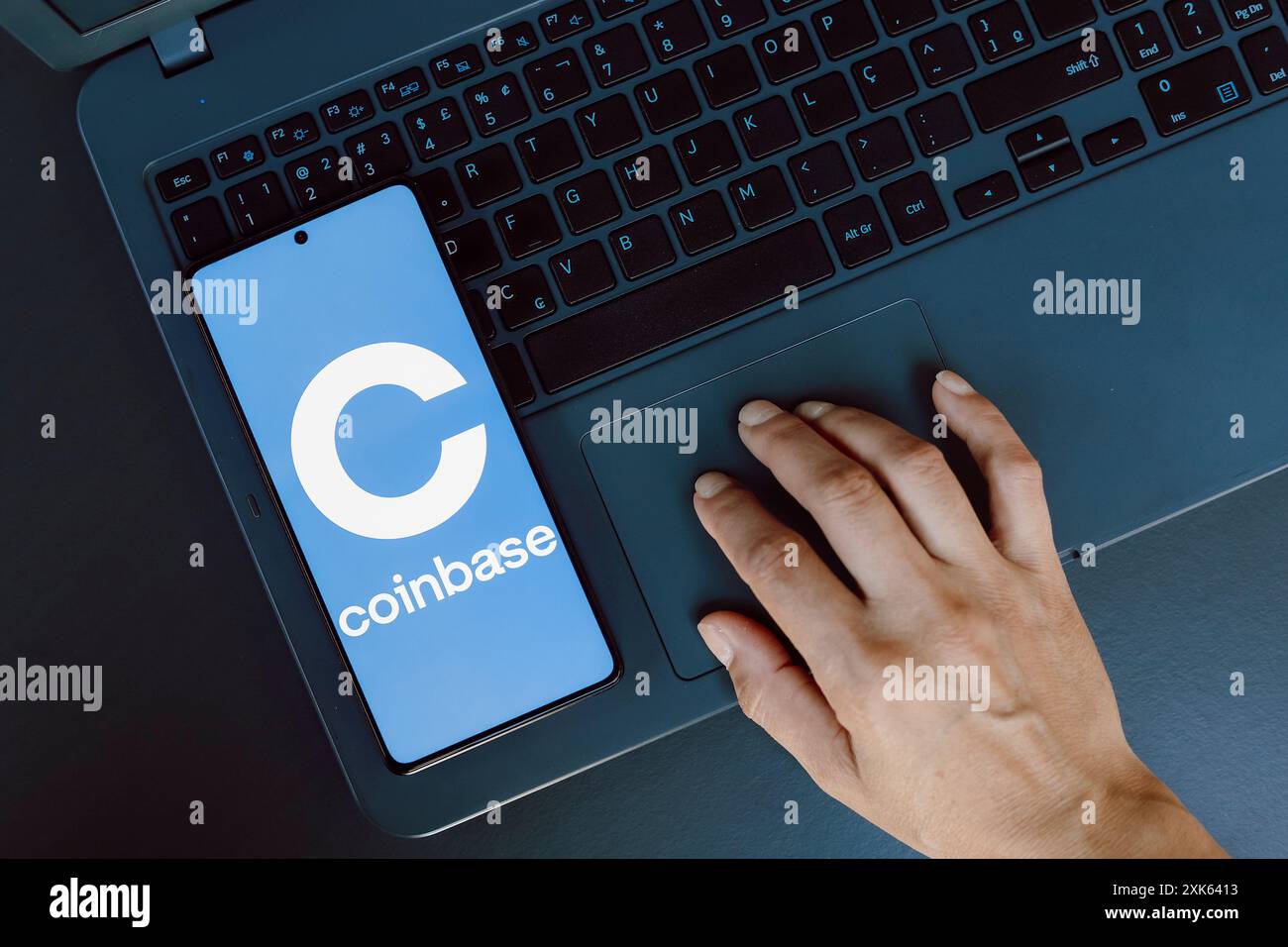 In this photo illustration, the Coinbase logo is displayed on a ...