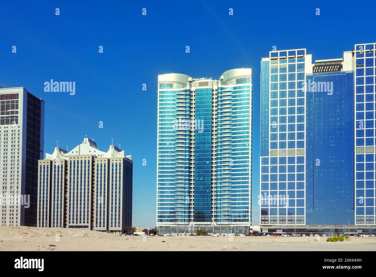 A modern new city rises straight out of the desert sands, satellite ...