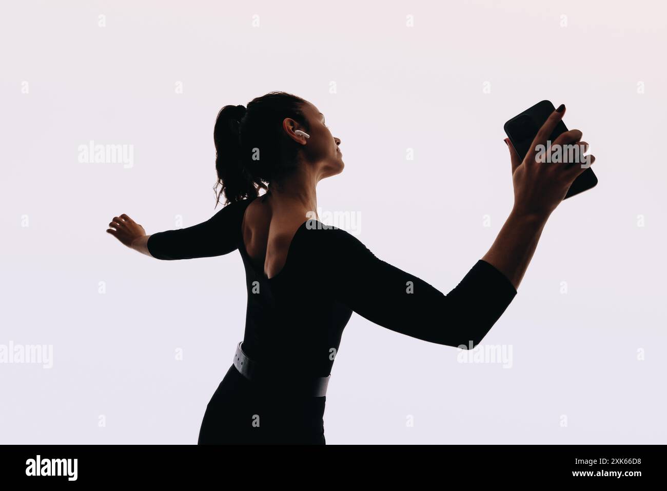 Artistic dancer with outstretched arms and expressive body language ...