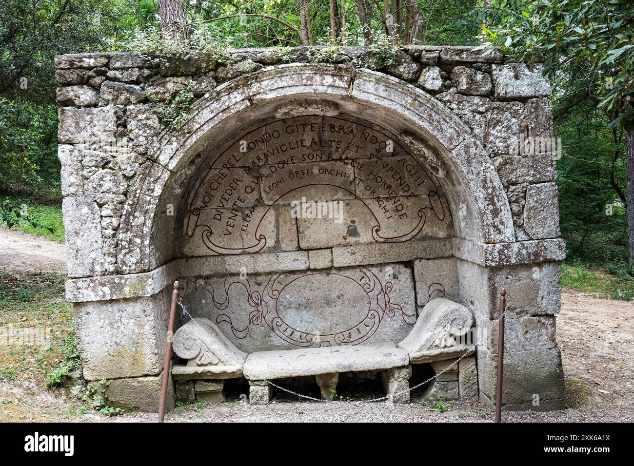 Close-up of the "etruscan bench" with ancient inscriptions in the lush ...